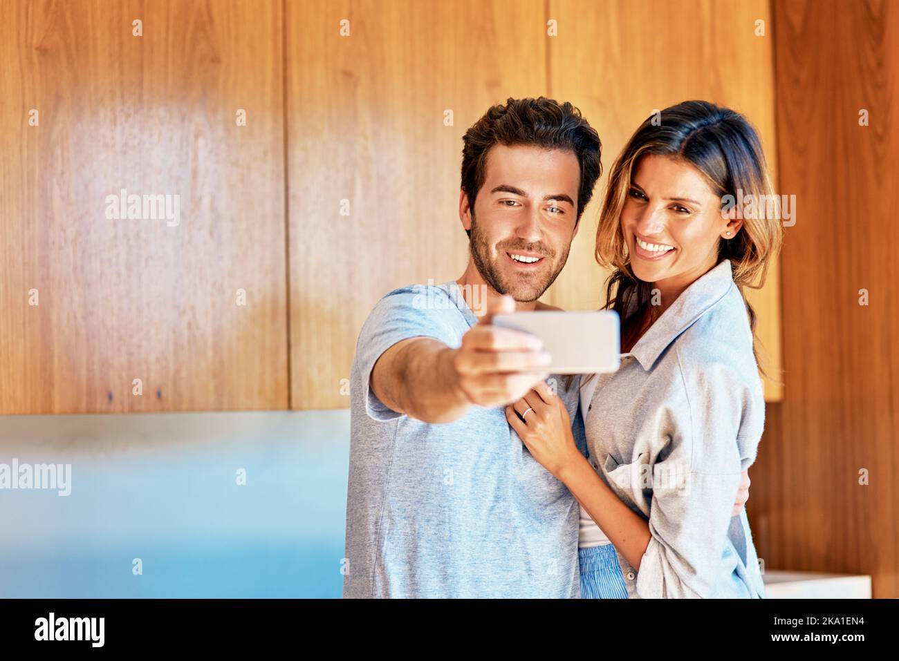 We take the best selfies together. a happy young couple taking a selfie together at home Stock ...