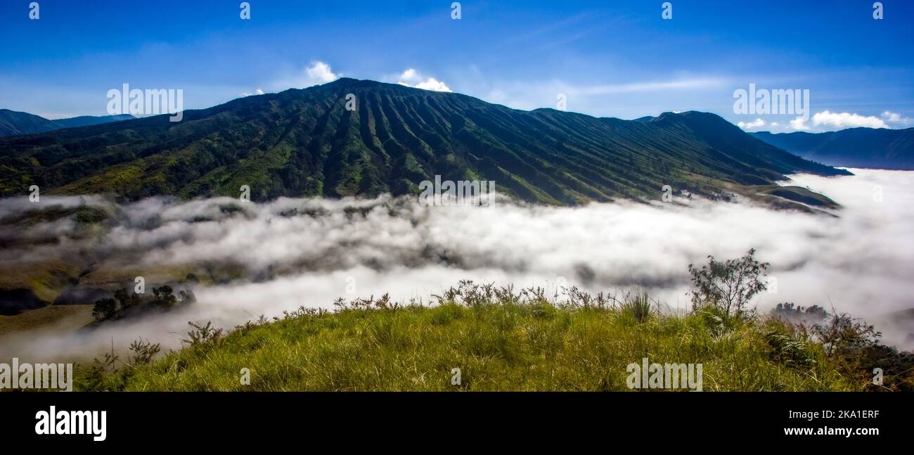 Mountain peaks in morning fog at Bromo Tengger Semeru National Park ...