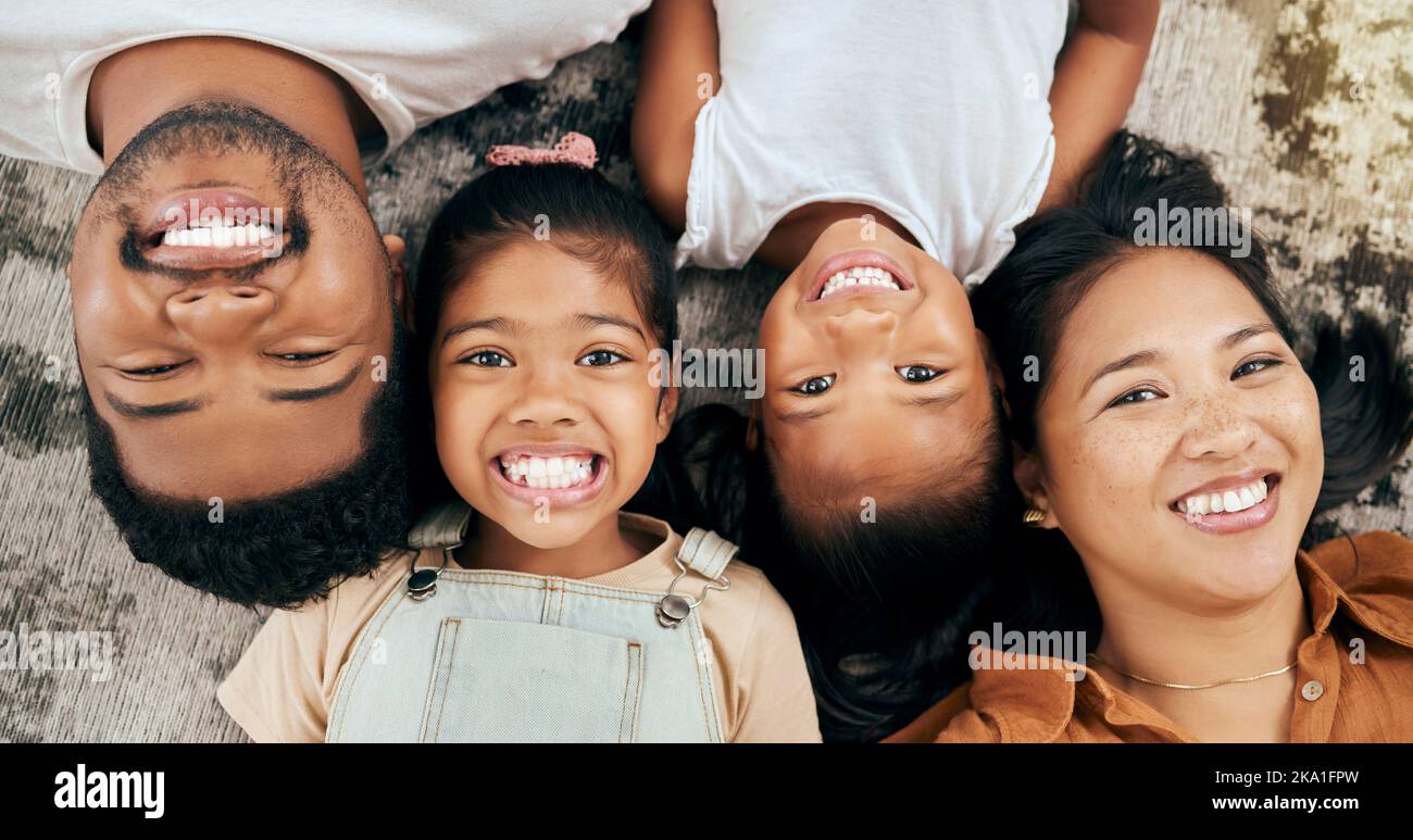 Happy, smile and portrait of family on floor with top view for care ...