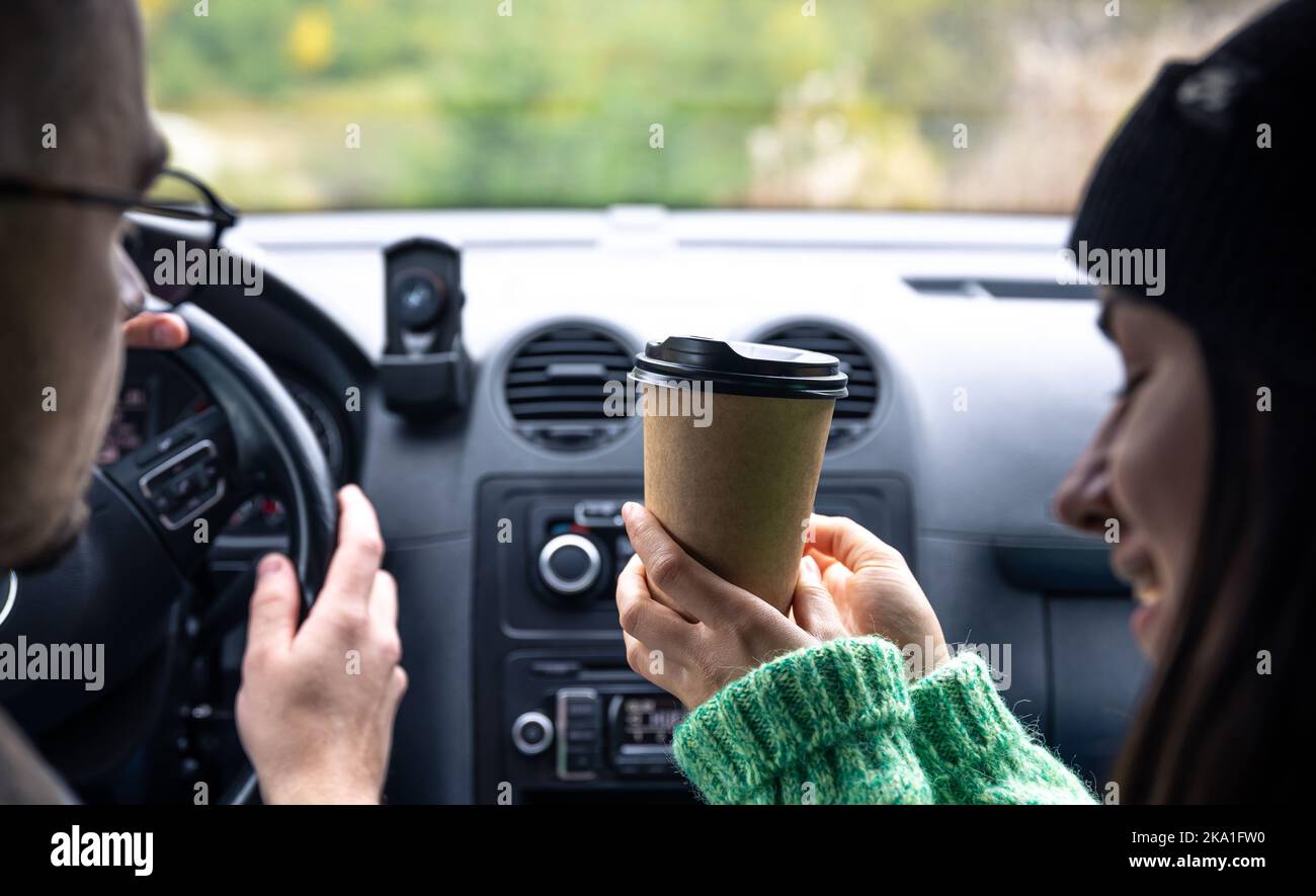 Rear back view from passenger seat of man and lady sitting inside car ...