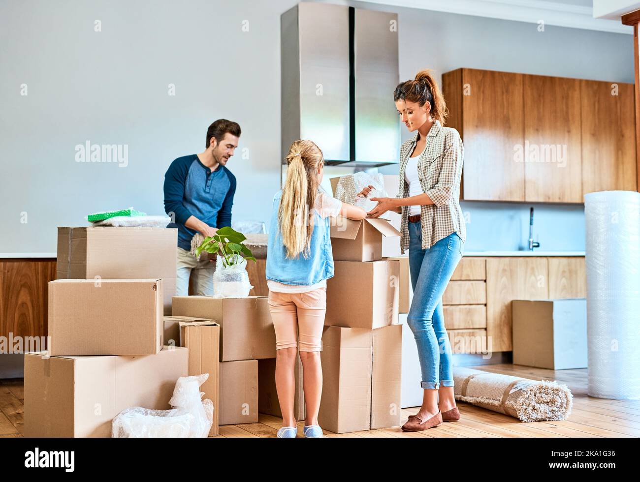 The whole family helping out in the house. a focused young family ...
