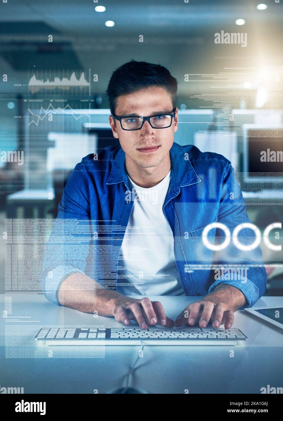 Time to crunch the numbers. Portrait of a focused young programmer working on his computer in ...