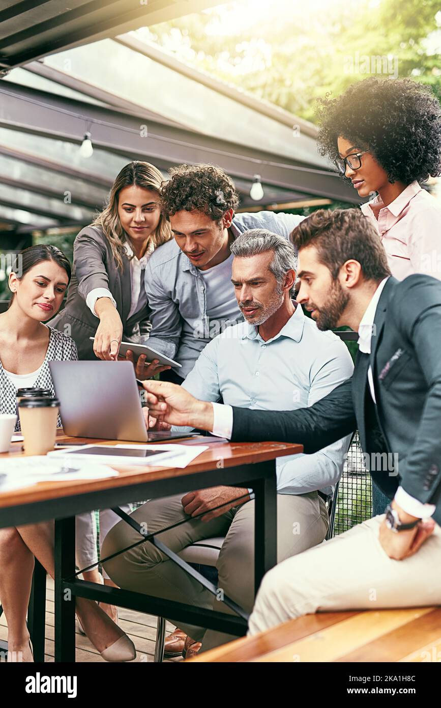 Lets explore that. a team of colleagues using a laptop together during ...