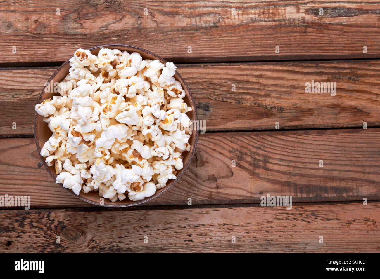 Popcorn in bowl food on wooden background Stock Photo - Alamy