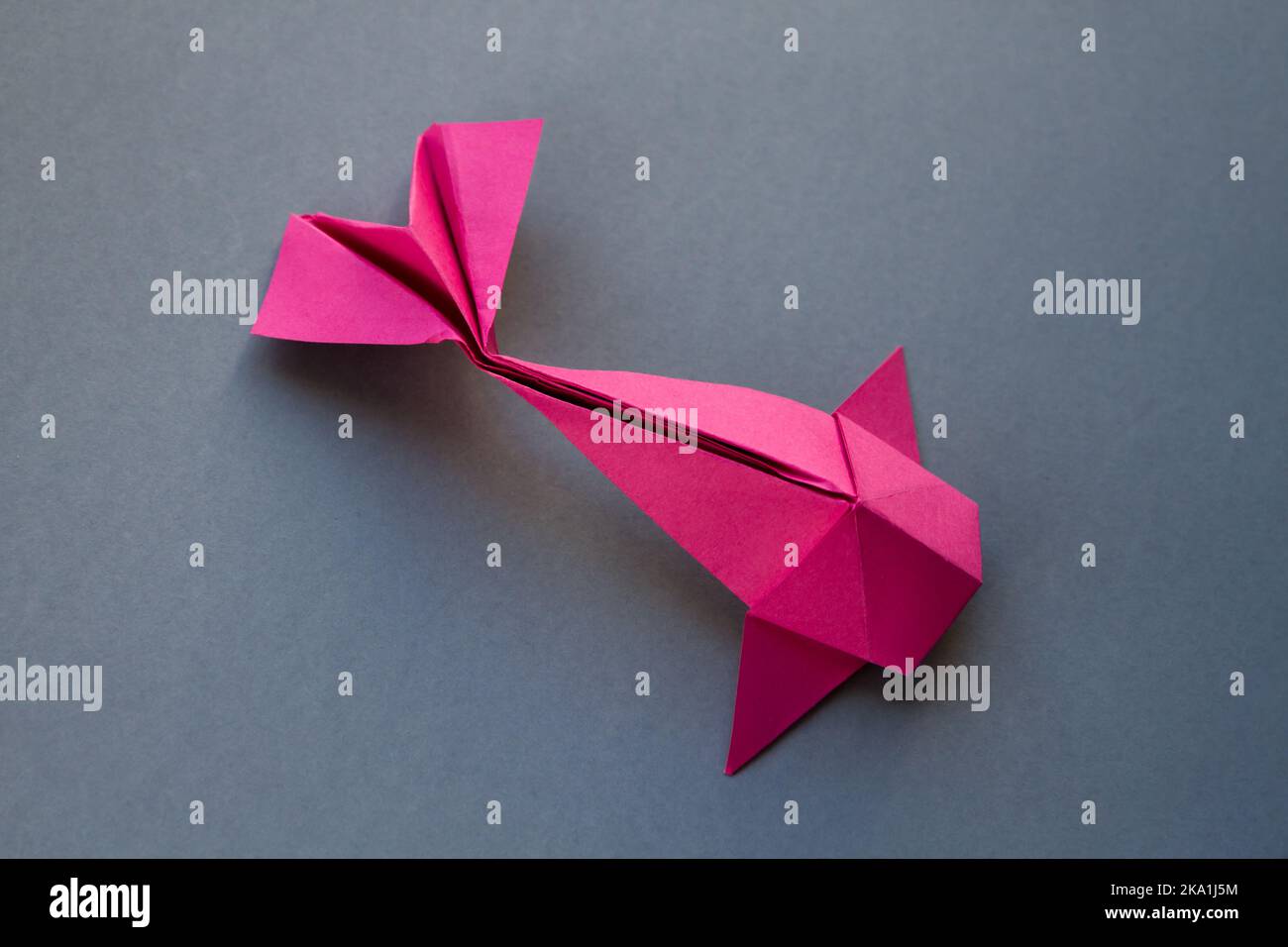 Pink paper fish origami isolated on a blank grey background Stock Photo ...