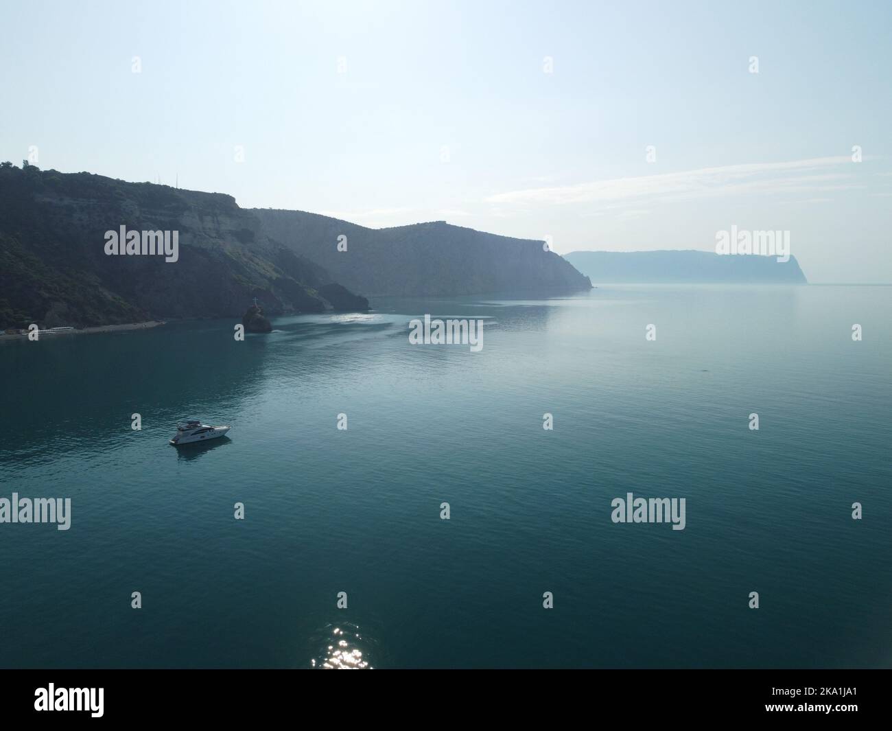 Aerial yacht on calm sea. Luxury cruise trip. View from above of white ...