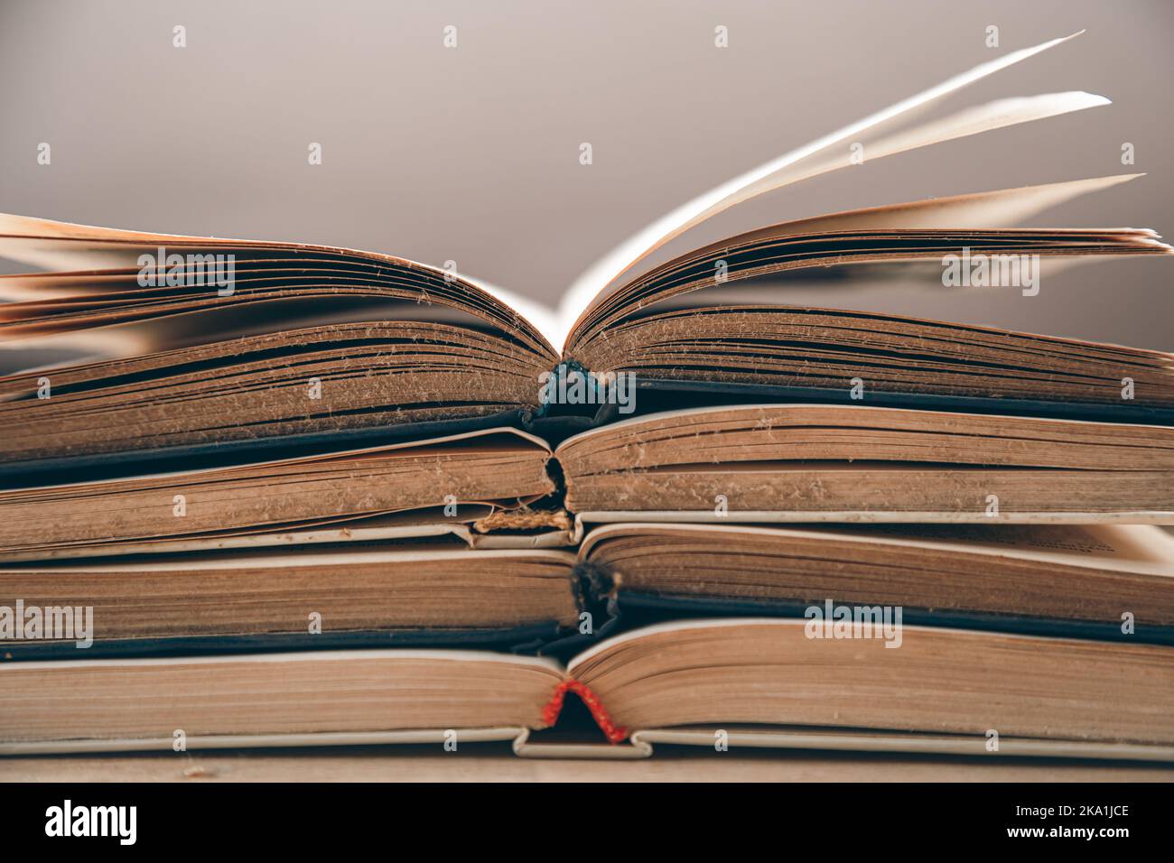 Open old books stacked, close-up on blurred background Stock Photo - Alamy
