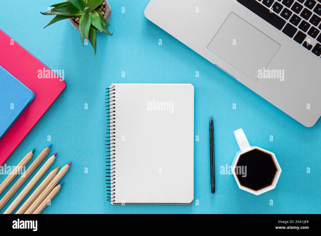 Flat lay, notepad, laptop and stationery on blue background Stock Photo ...