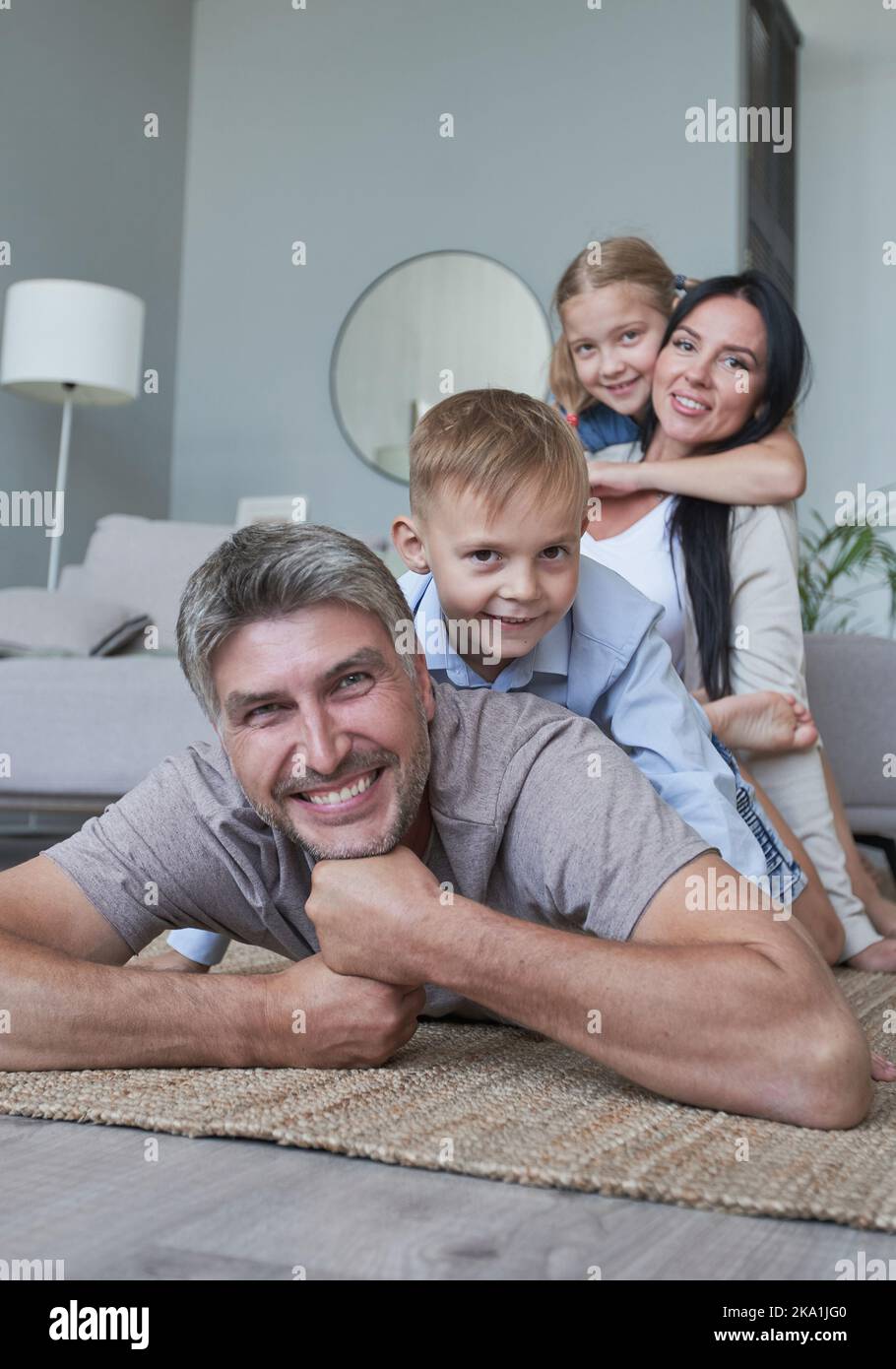 Photo of four members adopted family lying floor toothy smiling fluffy ...