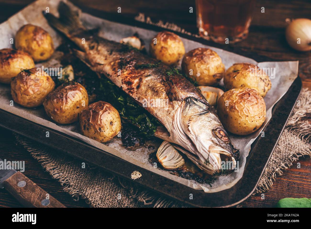 Freshly Baked Fish Stuffed with Sorrel and New Potatoes on Baking Sheet ...
