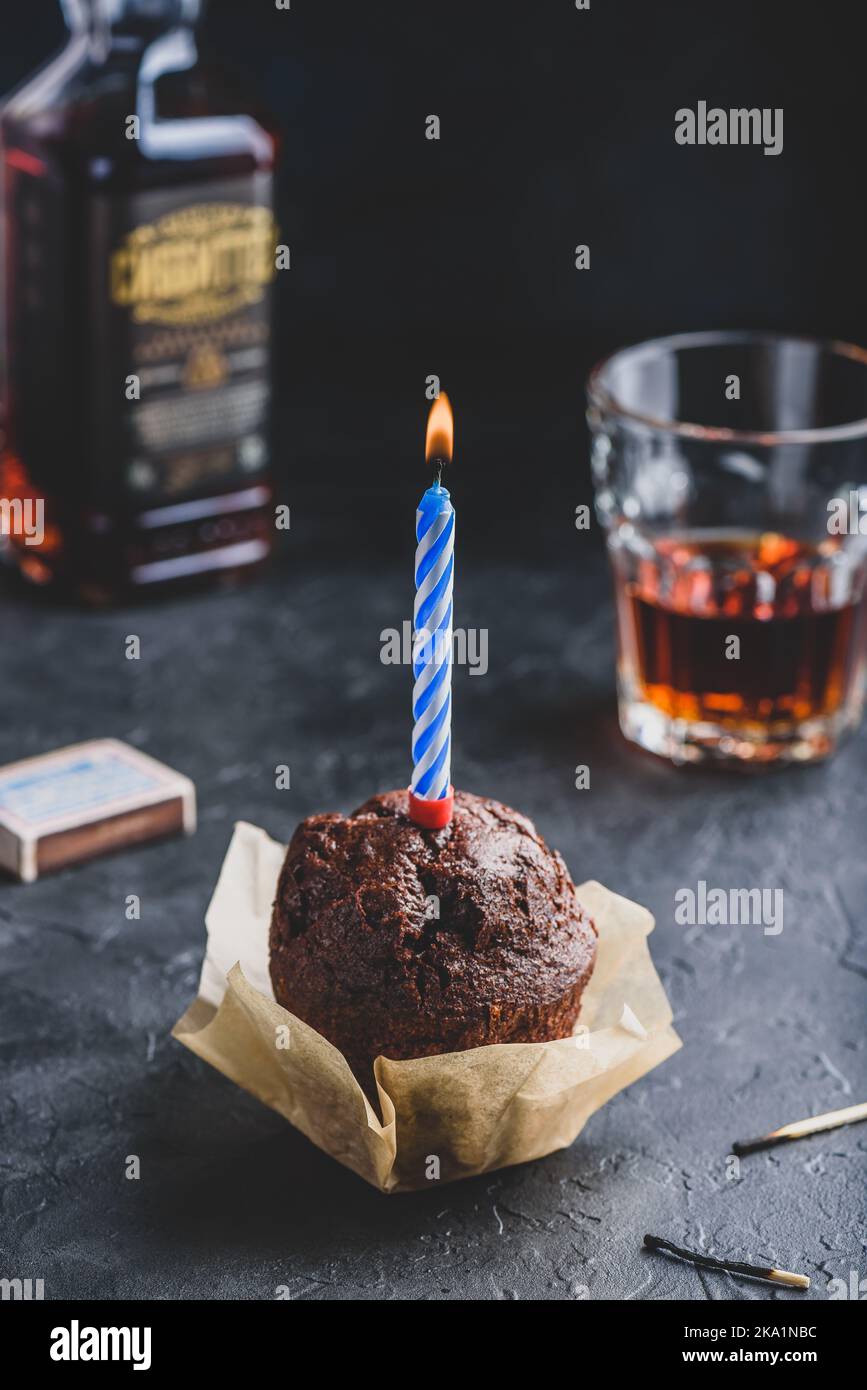 Chocolate muffin with birthday candle on dark concrete background Stock ...