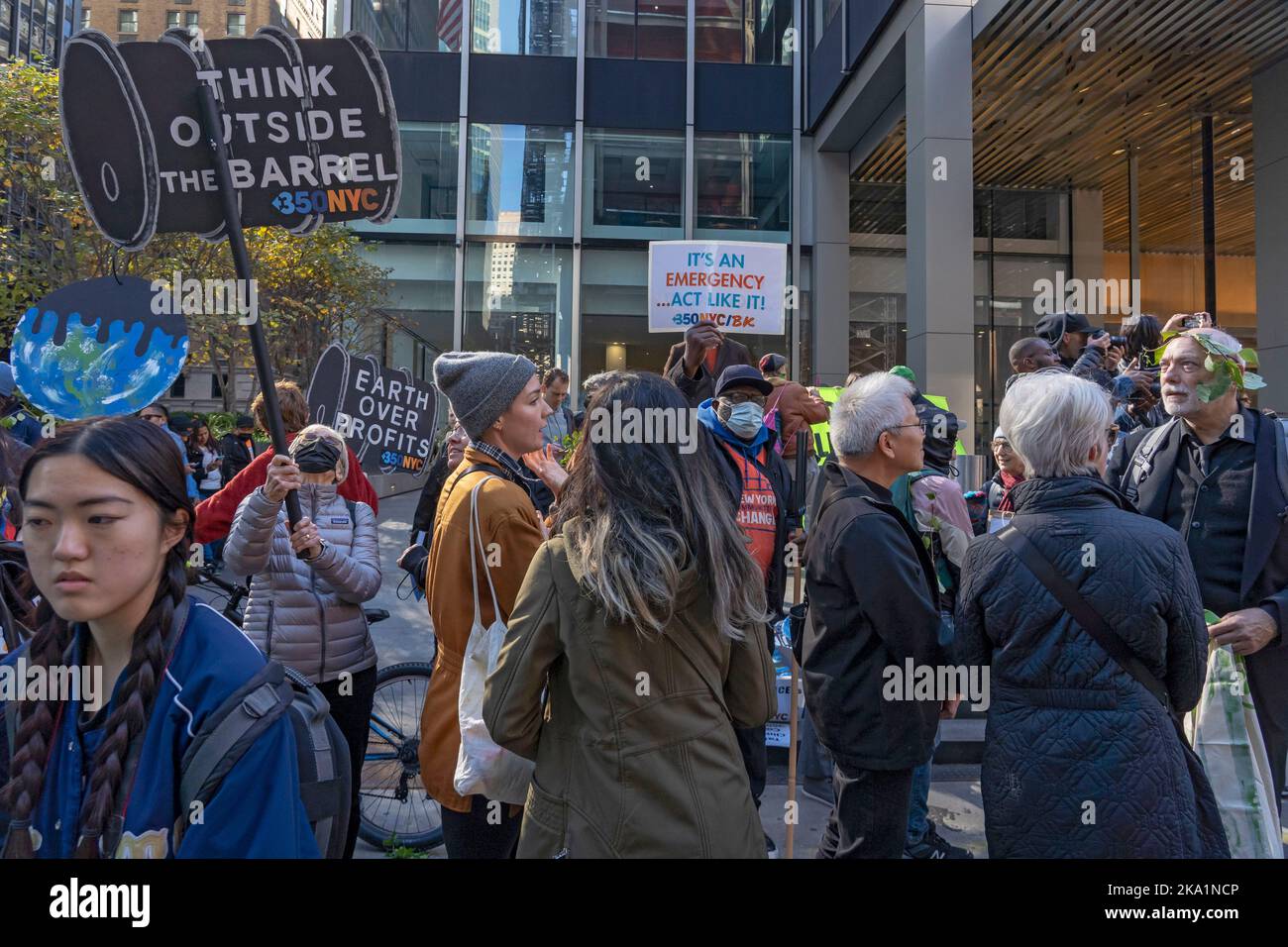 Climate activists hold placards in front of the NYC office of JPMorgan ...