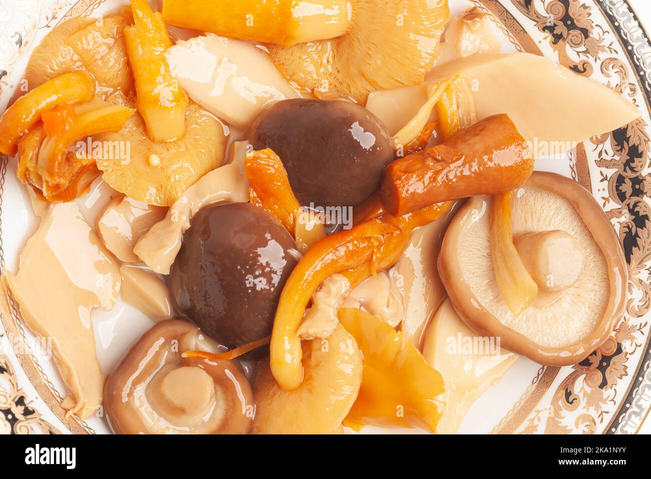 marinated mushrooms on plate isolated on white background, top view ...