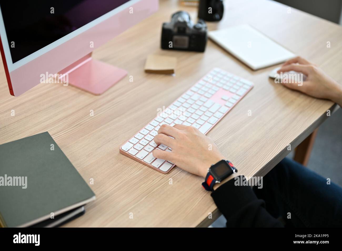 Professional male photographer working at his desk, using computer to ...