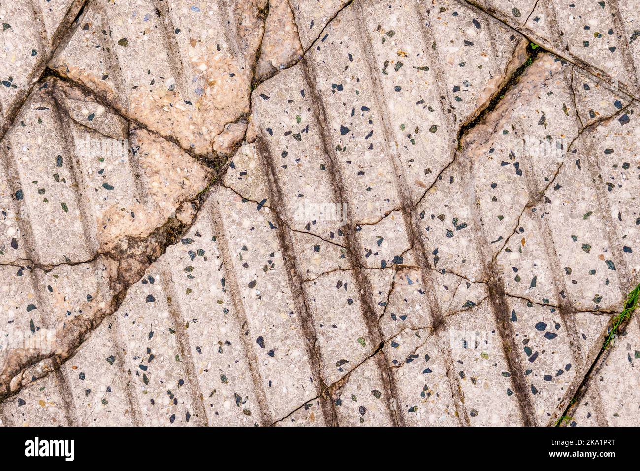 Broken damaged pavement with cracks. Deformed street tiles. Abstract background Stock Photo - Alamy