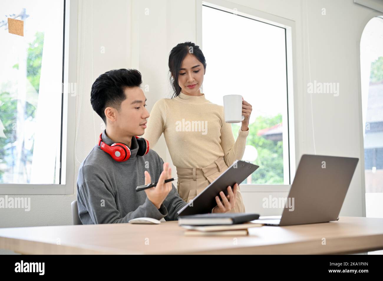 Elegant and professional Asian female boss having a conversation with ...