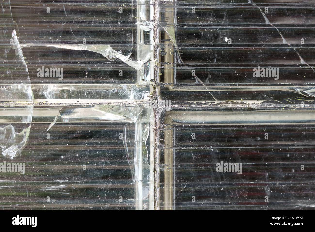 Cracked broken glass block of the exterior wall of the building ...