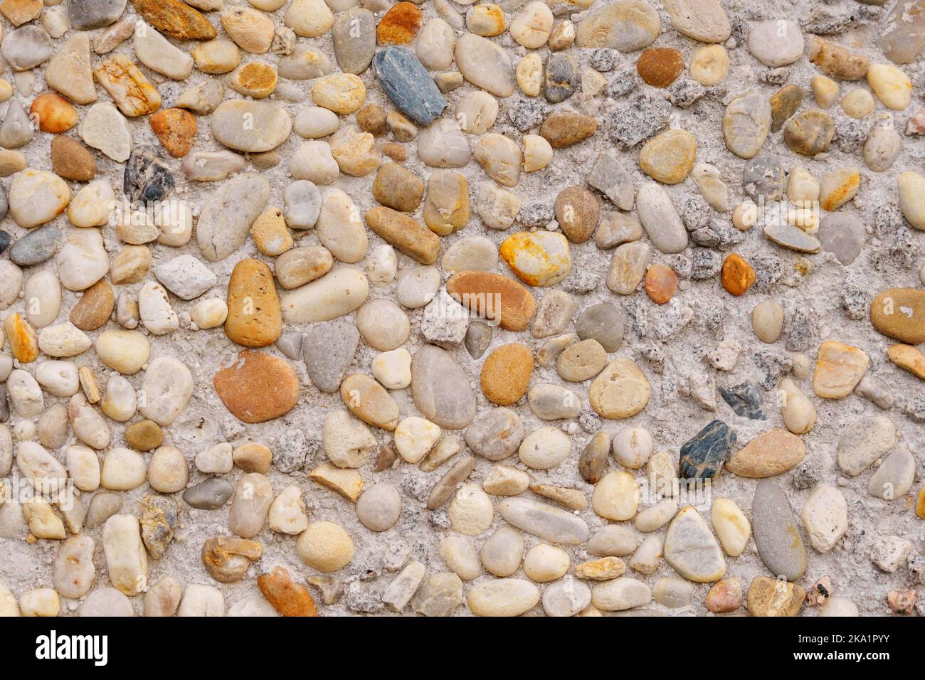 Colored pebble stone wall background. Abstract texture Stock Photo - Alamy