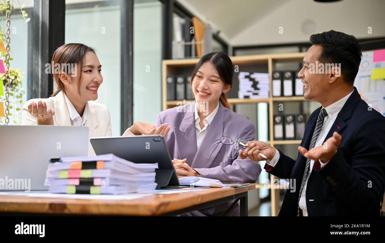 Happy and professional millennial Asian businesspeople or accountants ...