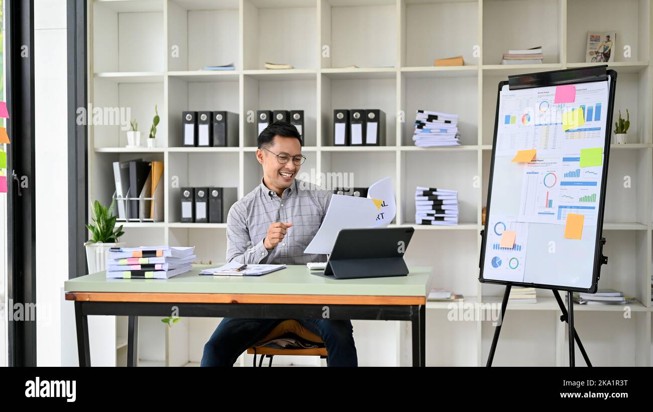 Happy and overjoyed adult Asian businessman or male financial analyst ...