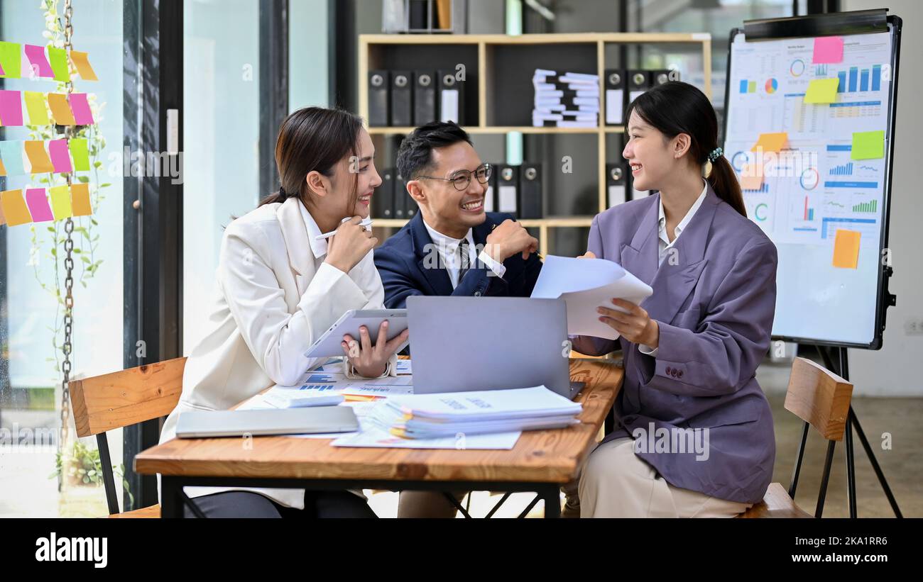 Team of millennial Asian businesspeople or accountants working together ...