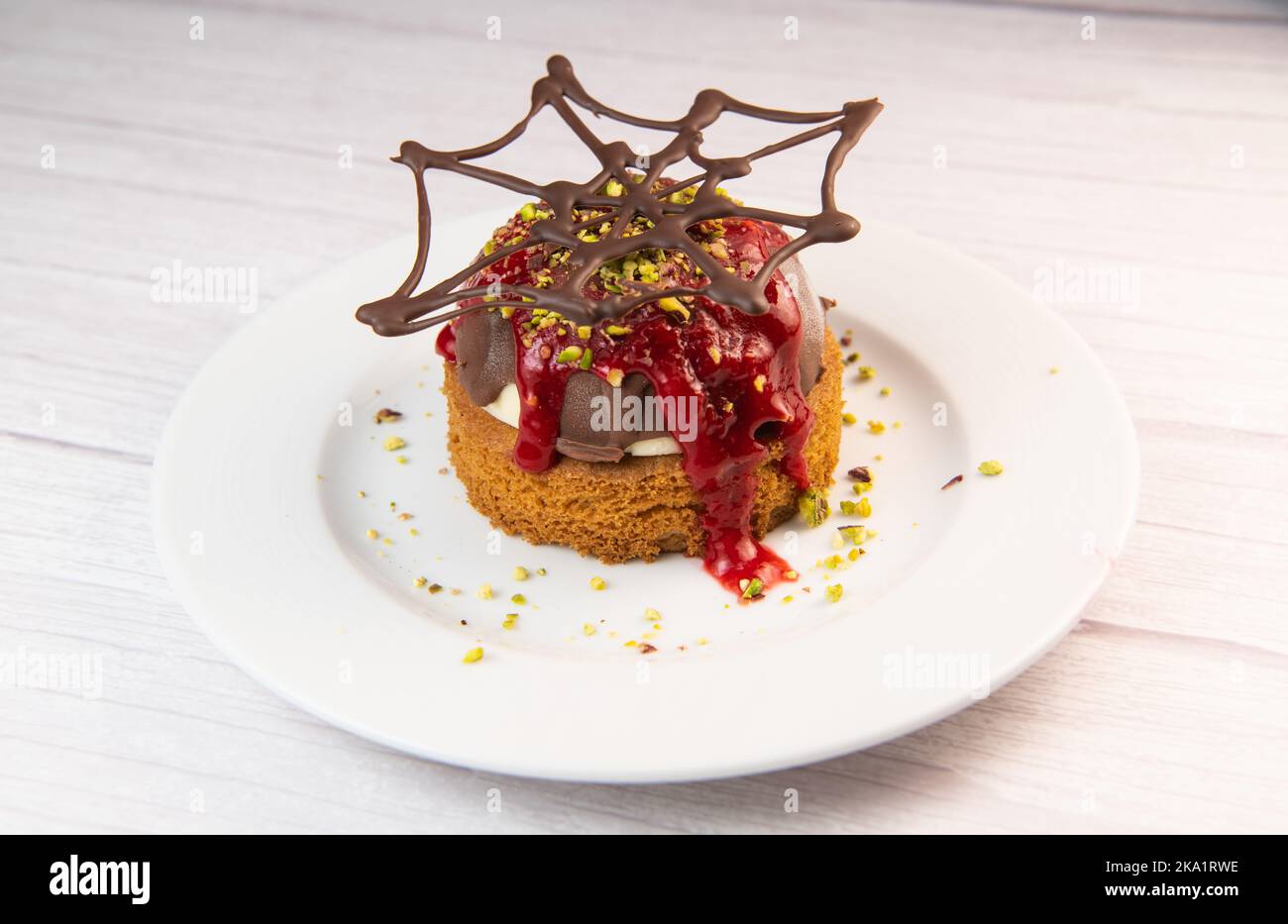 Chocolate sphere and its vanilla ice cream on its Breton shortbread and ...