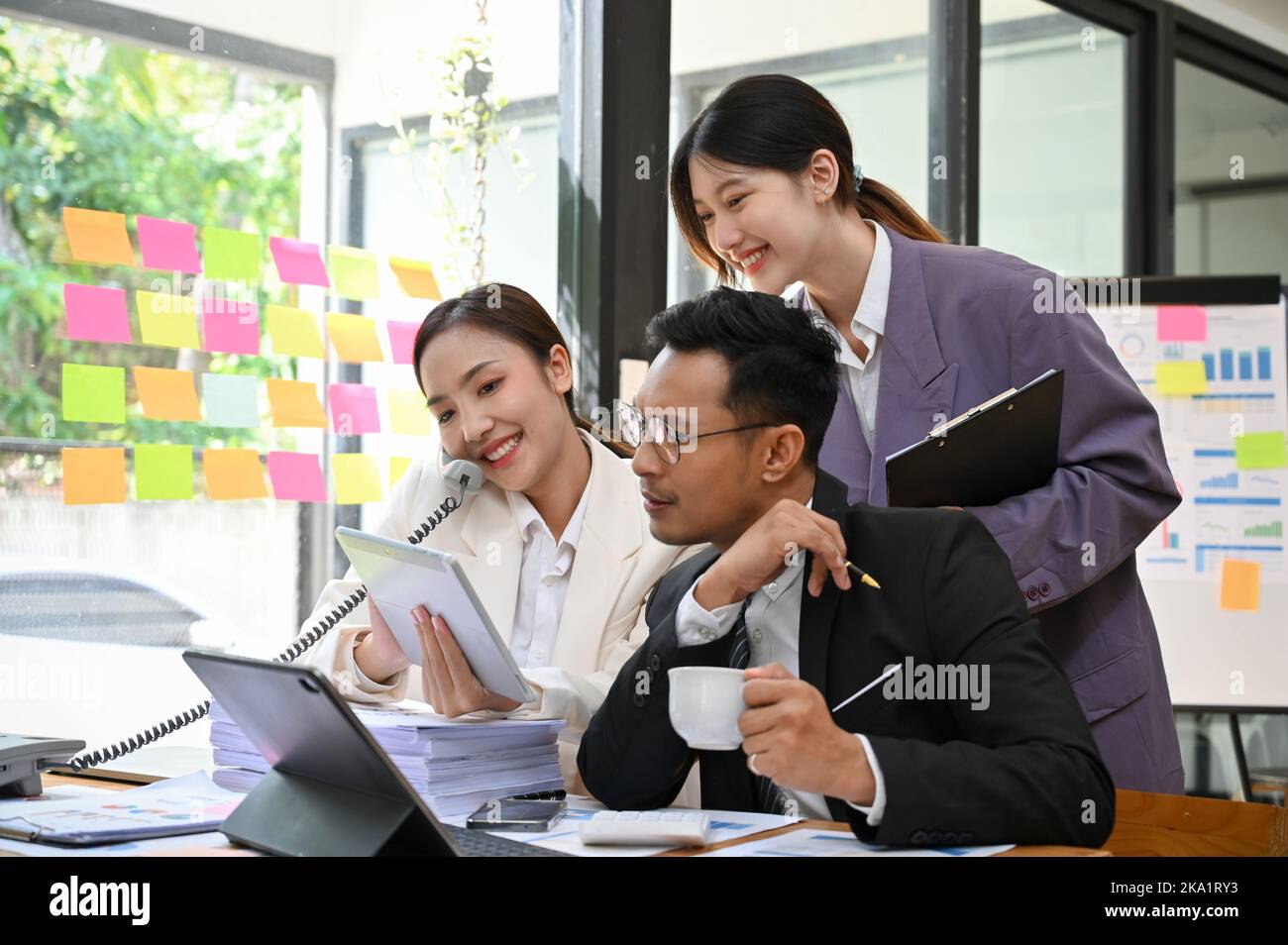 Professional millennial Asian businesspeople working together, having a ...