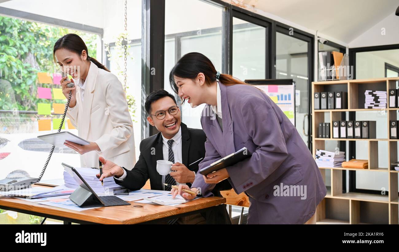 Professional and successful millennial Asian businesspeople enjoy ...