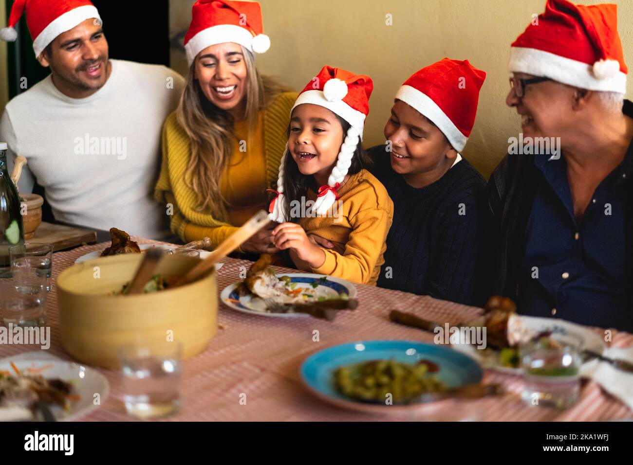 Happy Latin family enjoying the Christmas holidays having a dinner ...