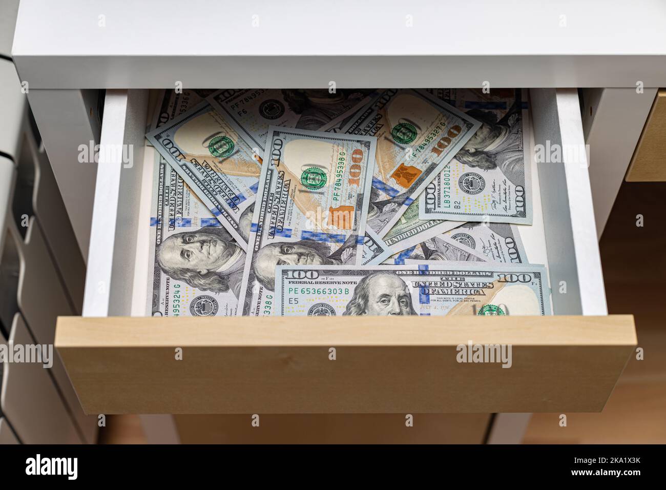 a hundred dollar bill is in a drawer. dollar is in the box. High ...