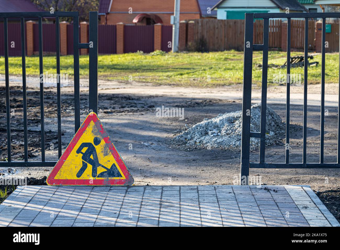 sign about the repair work in the park. park improvement. laying tiles ...