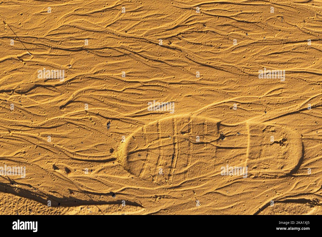 footprint of a boot tread on yellow sand. footprints in the sand Stock ...