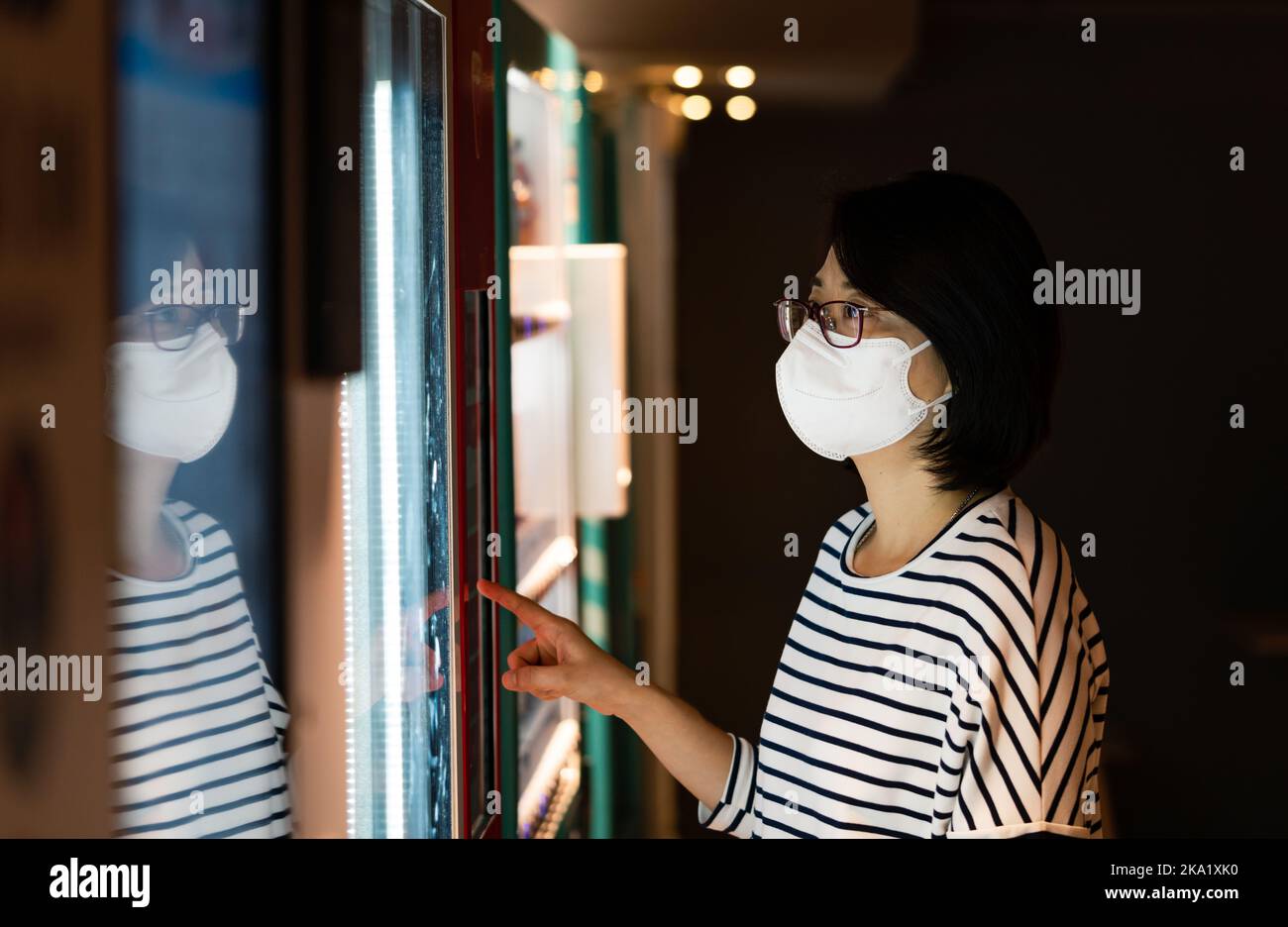 Profile portrait of middle-aged Asian woman buying drinks or other ...