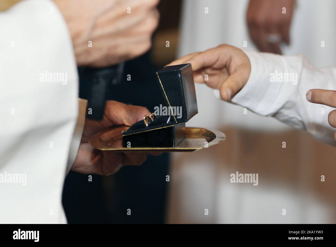 The priest in the church passes the wedding rings Stock Photo - Alamy