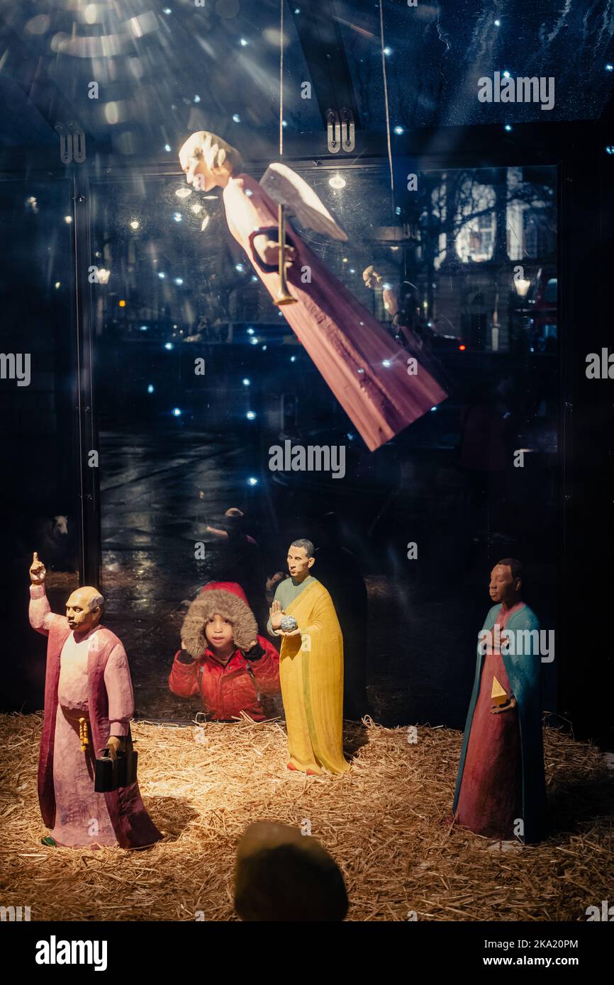 A young girl peers into the Nativity scene at Trafalgar Square, London ...