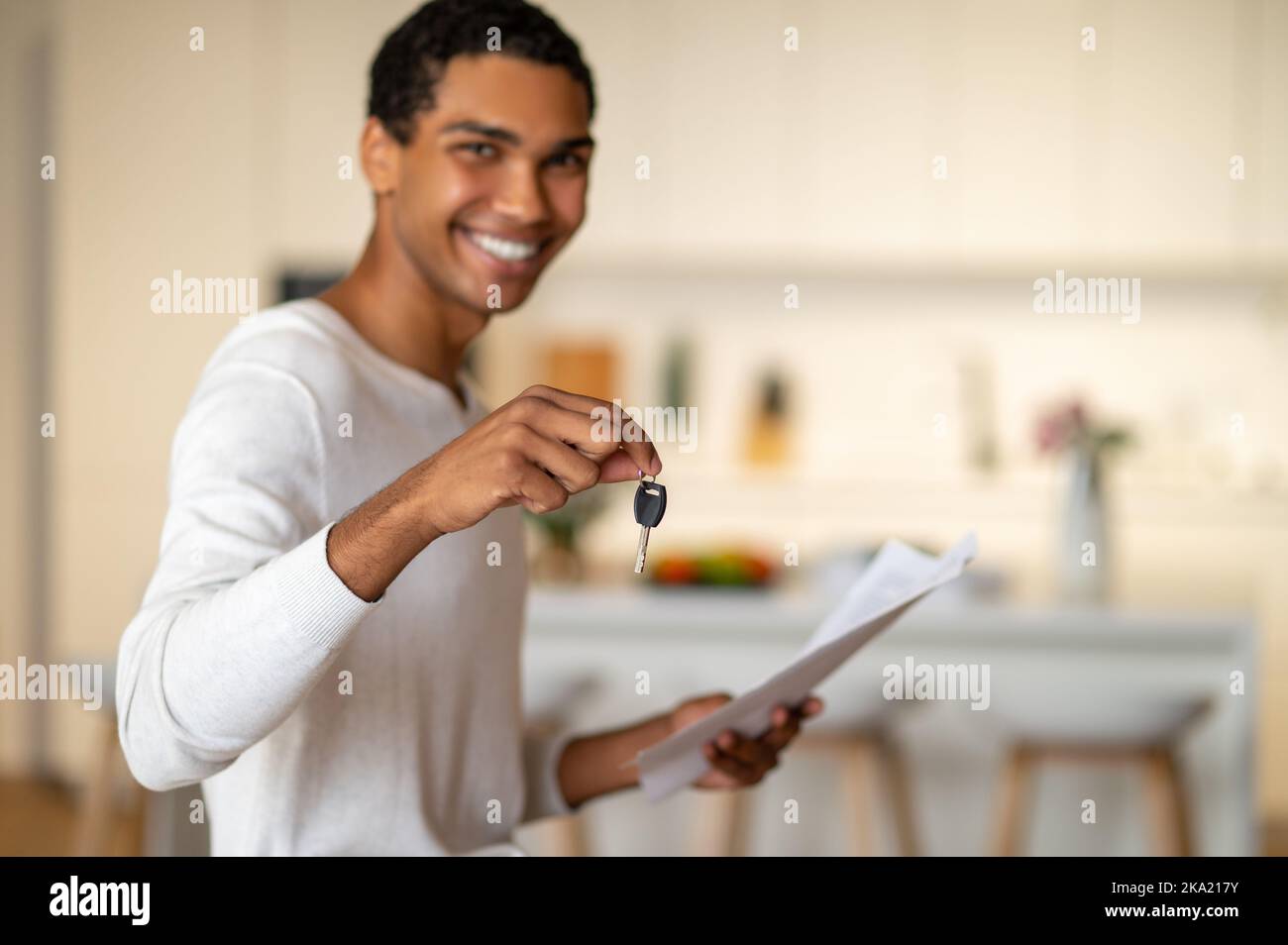 Happy young black man standing in the kitchen with keys in hands Stock ...