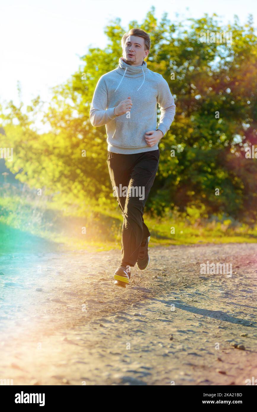 Running man jogging in rural nature at beautiful summer day. Sport ...