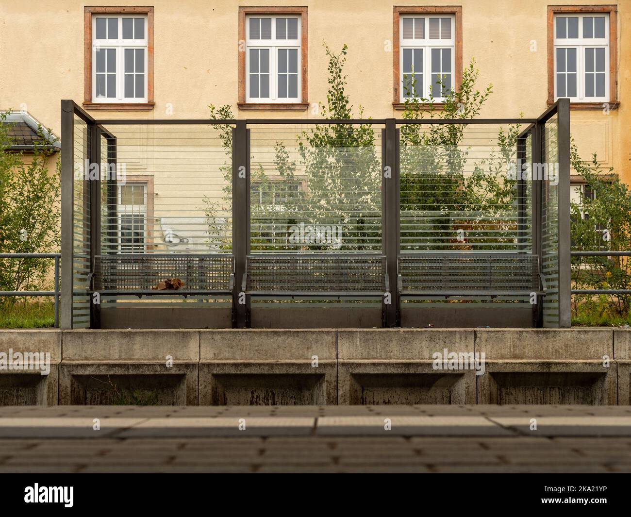 Waiting area on a train station platform. The place is dirty and the ...