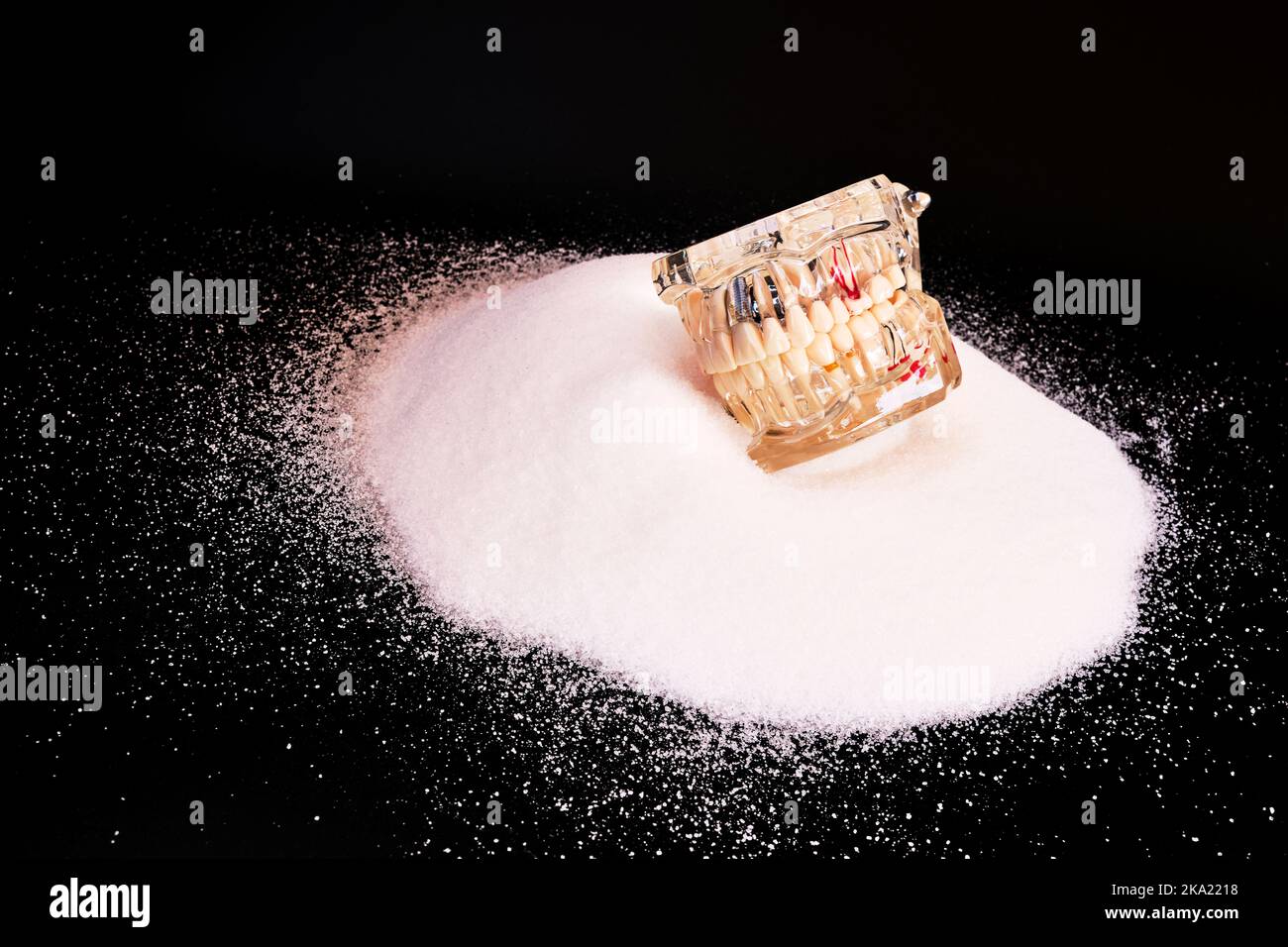Heap of white sugar on black background, glucose energy causes tooth ...