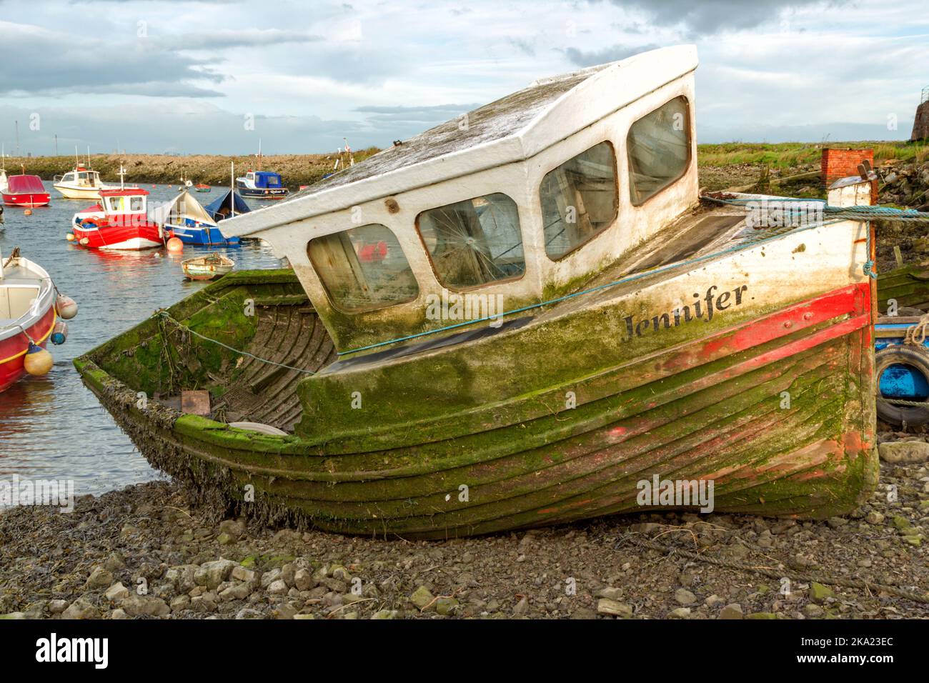 An old and decrepit small fishing boat called Jennifer tied up and out ...