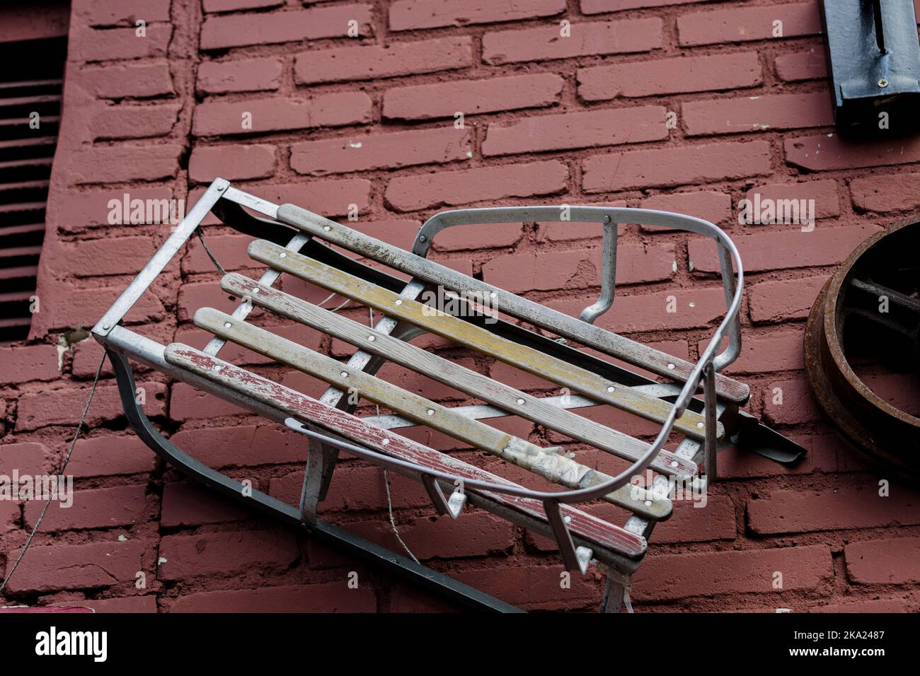 vintage wooden sled on brick wall. antique sledge Stock Photo - Alamy