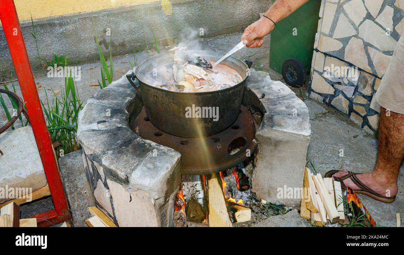 Traditional homemade soup on camp fire in the Danube Delta Stock Photo ...