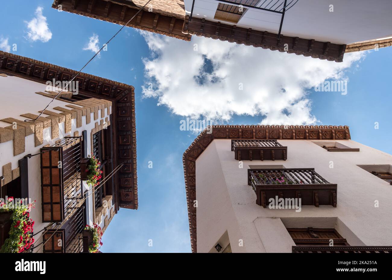 Wooden eaves of houses old village of Spain, carved wood carving blue ...