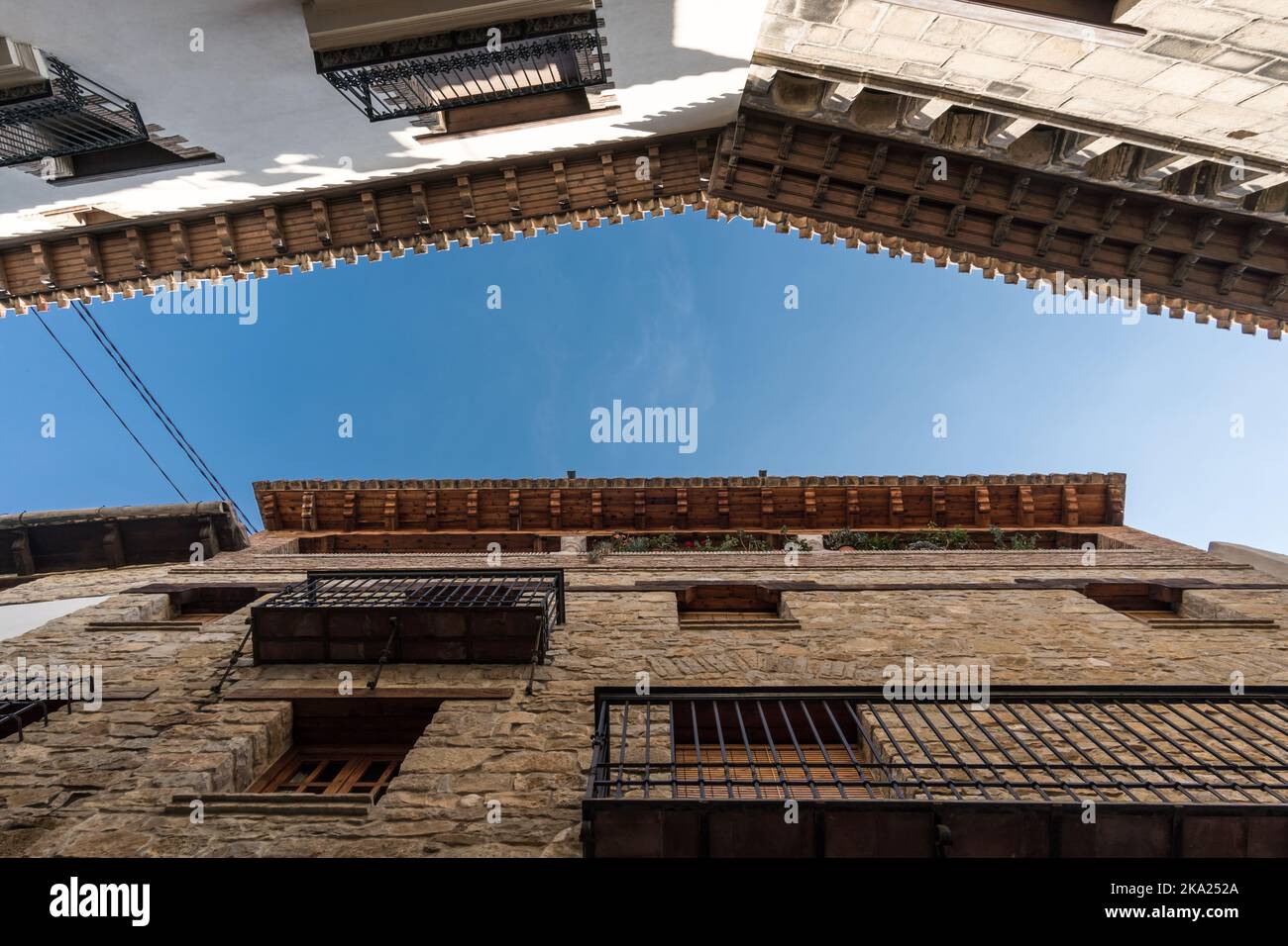 Wooden eaves of houses nearby in an old village of Spain, carved wood ...