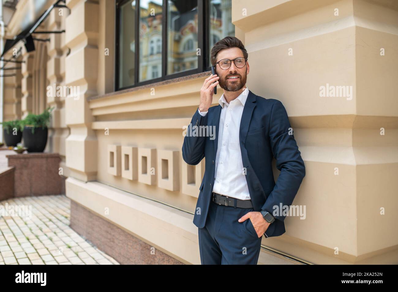 Elegant businessman waiting for the appointment and looking anticipated ...