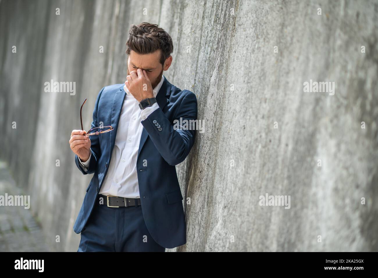 Young businessman looking looking tired after work Stock Photo - Alamy