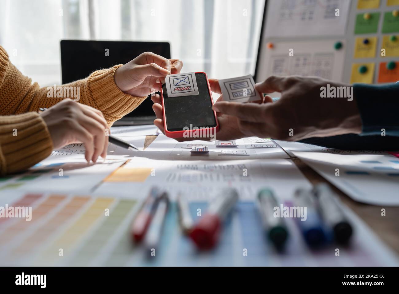Group of ux developer and ui designer brainstorming about app interface design at modern office ...