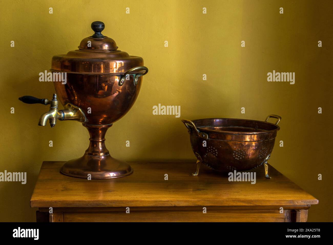 Still life views of a copper decanter with tap, and bowl, in the ...