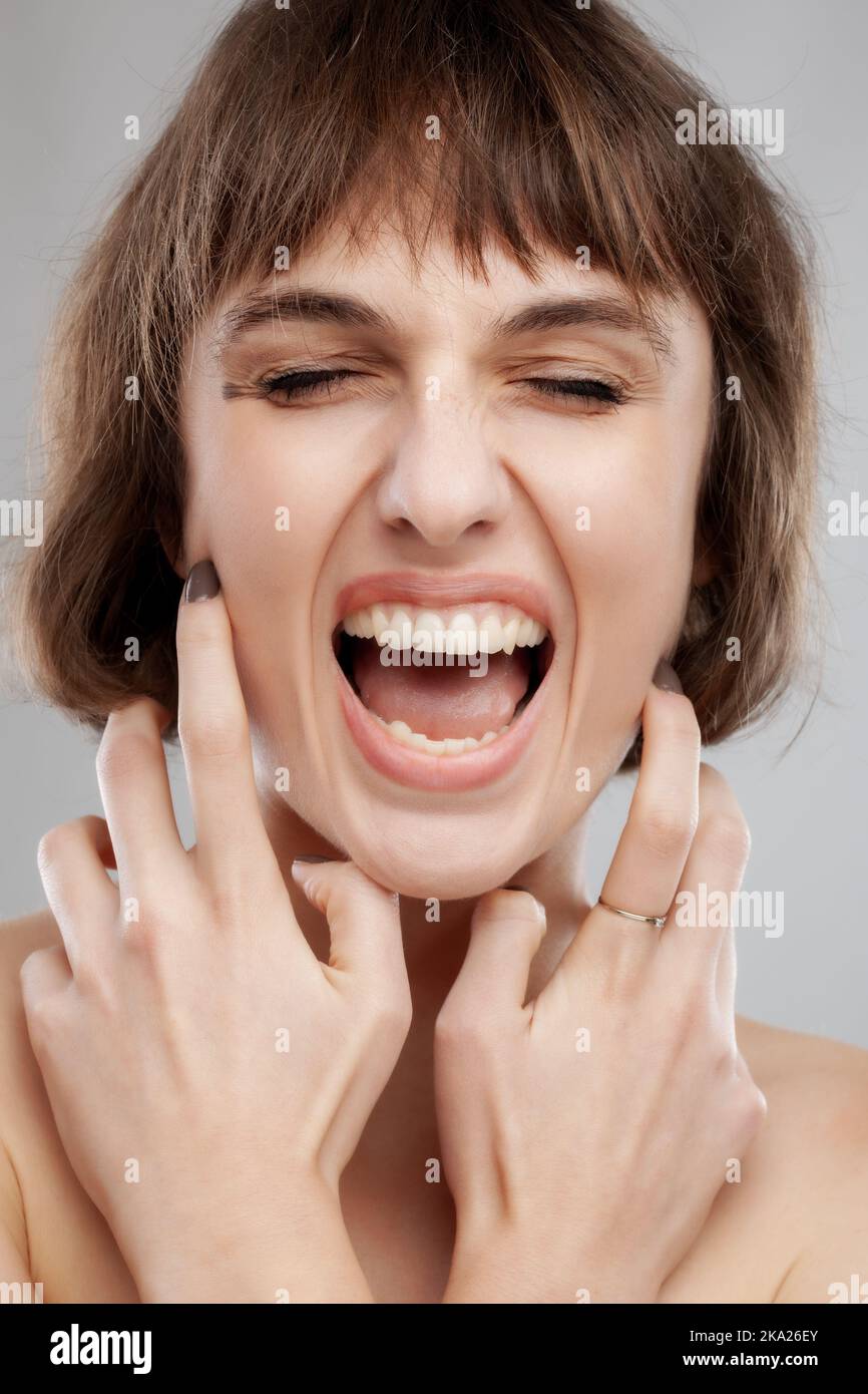 beauty portrait of a brunette girl with short hairstyle. screaming and ...