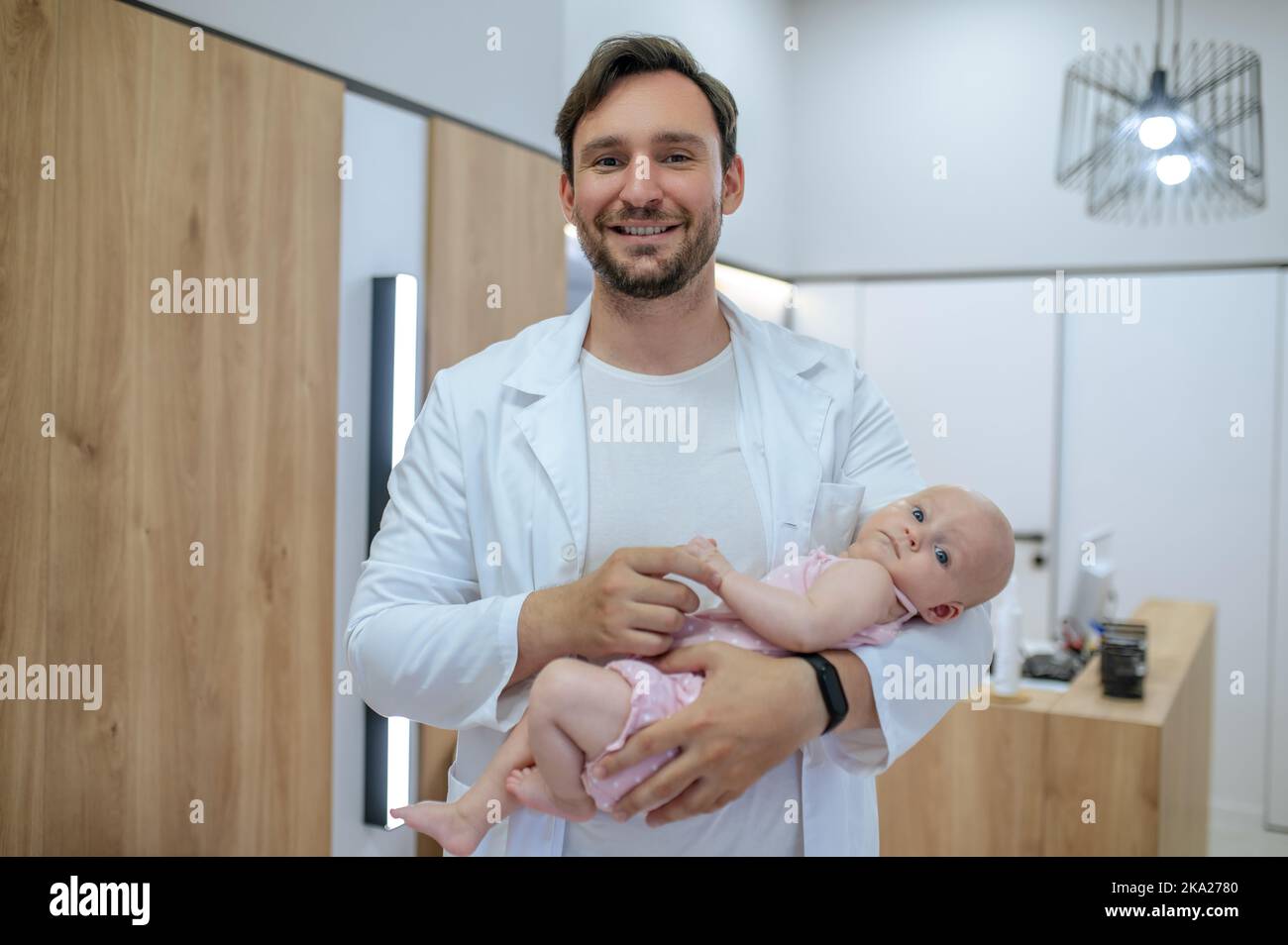 Young pediatrician posing for the camera with a neonatal patient Stock ...